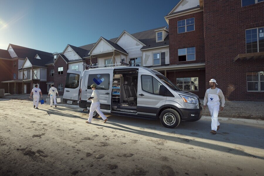 A work crew walking away from a 2023 Ford Transit® Van at a ...