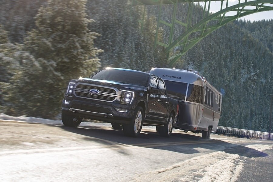 Image of a 2023 Ford F-150® pulling a airstream camper on a mountain ...