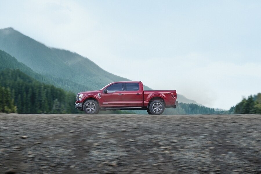 2023 Ford F-150® XLT Crew Cab in Rapid Red being driven on a mountain road