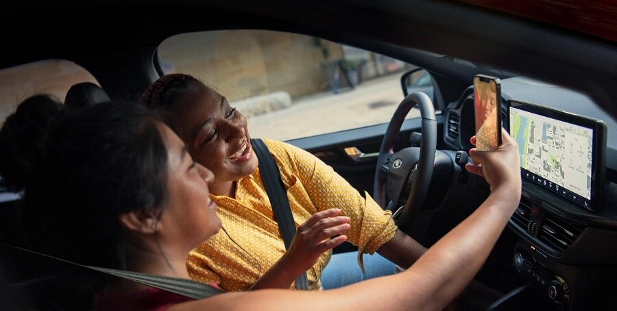 Close-up of interior of a 2023 Ford Escape® as people look at their ...